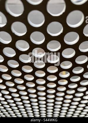 Abstract hole punched steel Stock Photo - Alamy
