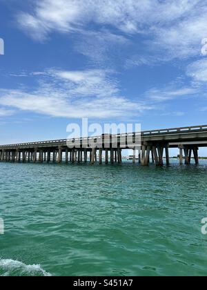 Boat view of the Destin, Florida bridge over the Gulf of Mexico water ...