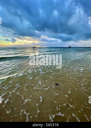 Sunset at the sea. It's raining Stock Photo - Alamy