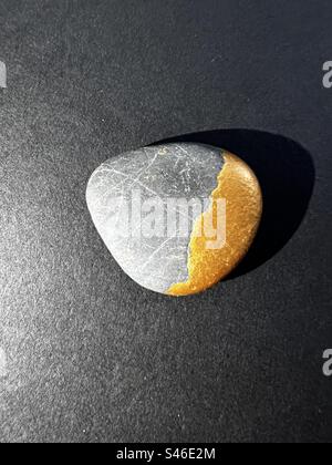 Gold painted rock Stock Photo - Alamy