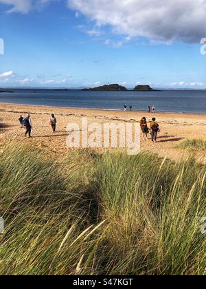 People Walking on Yellowcraig beach, with a view towards Fidra ...