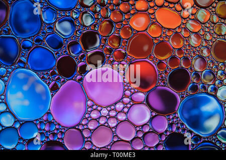 Abstract colorful backdrop with oil drops and waves on water surface ...