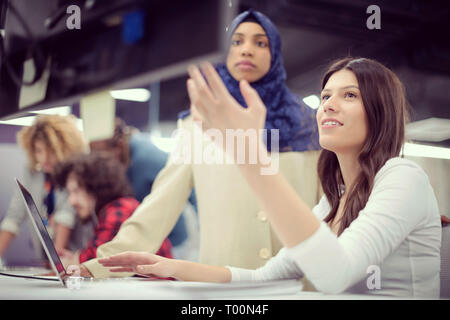 young multiethnics business team of software developers working ...