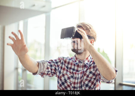 The young man with virtual reality goggles Stock Photo - Alamy