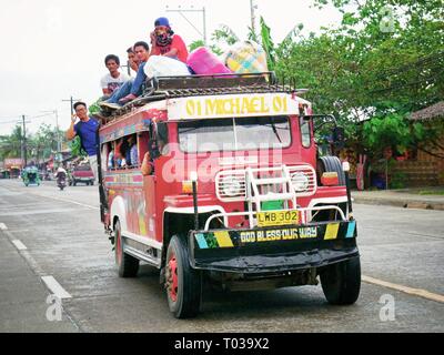 TAGUM CITY, PHILIPPINES—FEBRUARY 2016: Passengers riding a motorcycle ...