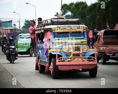TAGUM CITY, PHILIPPINES—FEBRUARY 2016: Passengers riding a motorcycle ...