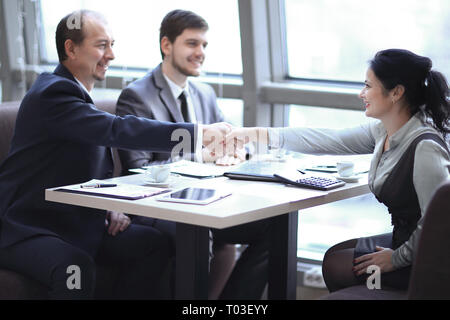 handshake Manager and the client over a Desk Stock Photo - Alamy