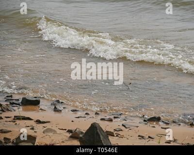 Waves slapping against the rocky shores of a lake Stock Photo - Alamy