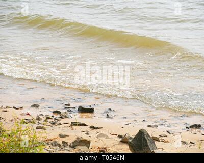 Waves slapping against the rocky shores of a lake Stock Photo - Alamy