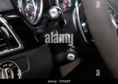 Heated steering wheel control buttons with blurred dashboard in car ...