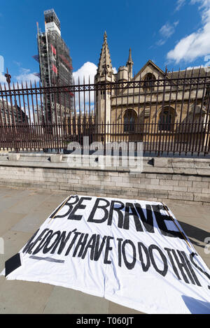 Westminster, London, UK. A lone banner outside the Houses of Parliament ...