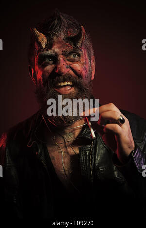 Happy Halloween. red devil or zombie monster hand holding a halloween ...