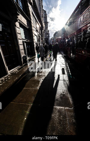 People walk in the sun in London, Tuesday, June 23, 2026, as a heat ...