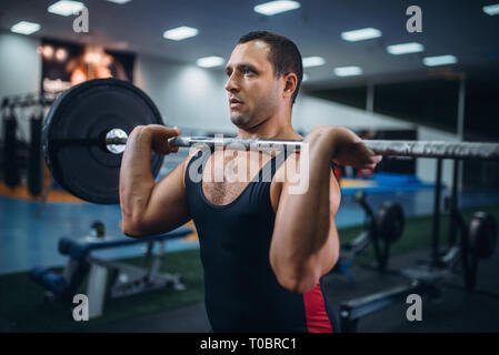 Strong male powerlifter doing deadlift a barbell in gym. Weightlifting ...