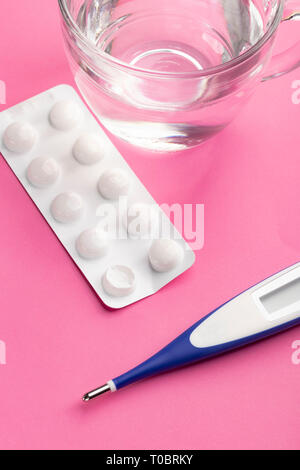 Hand holding thermometer and pills for fever and illness Stock Photo ...