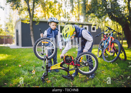 Boy Fixing Wheel Of Bike Stock Photo - Alamy