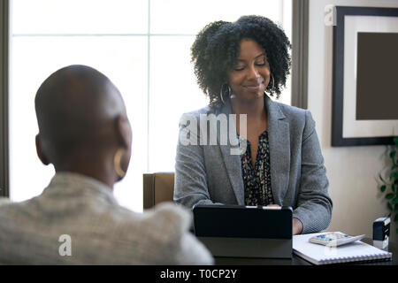 Couple of black female businesswomen or partners arguing at work or a ...
