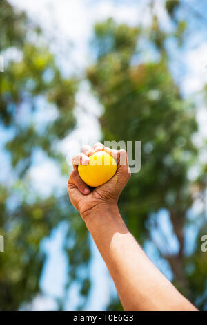 Hand squeeze yellow stress ball, isolated on white background, anger ...