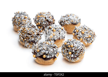 Homemade profiteroles covered with coloured sugar sparkles isolated on ...