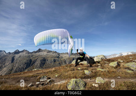 A man sits on a rock near the sea and enjoys the sea view. Active ...