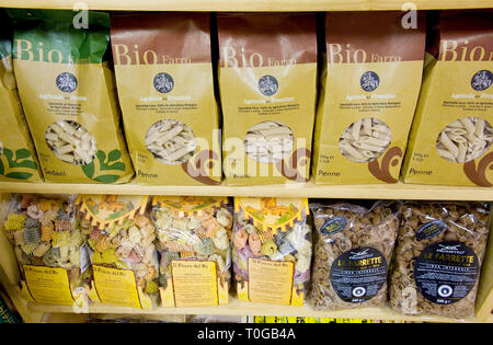 Displays of various pasta and jars of pasta sauce on display in a ...