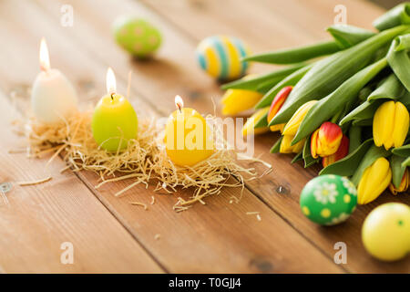candles in shape of easter eggs and tulip flowers Stock Photo - Alamy