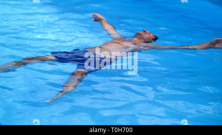 Blue swimming trunks floating on the surface of a swimming pool Stock ...