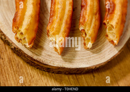 spanish fritters served on top of a wooden board and hot chocolate ...