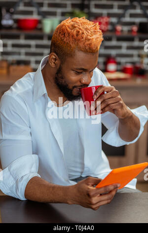 Nice handsome man taking a sip Stock Photo - Alamy