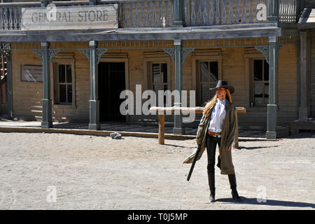 Cowboy actors re-enact a gunfight scene for tourists on a former ...