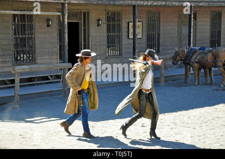Cowboy actors re-enact a gunfight scene for tourists on a former ...
