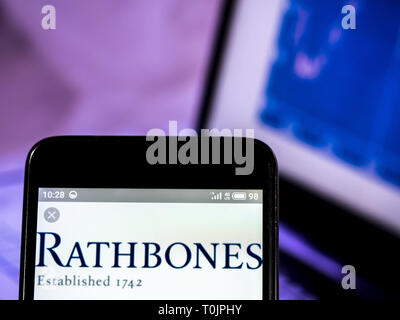 The Rathbone Brothers logo is seen on an LED screen in the background ...