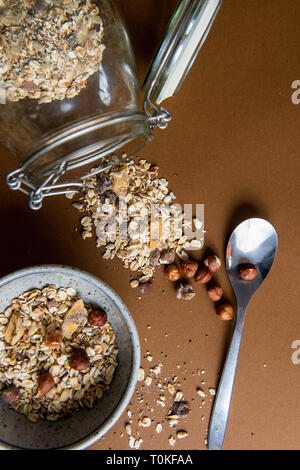 Breakfast cereal spilled on a brown backdrop Stock Photo - Alamy