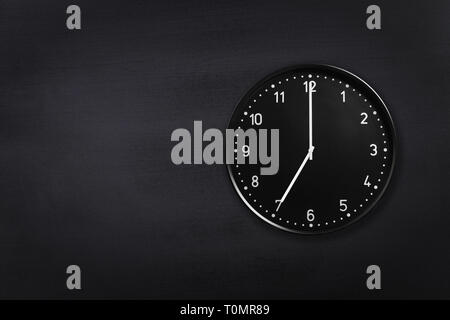 Wall clock show seven o'clock on white marble texture. Office clock ...
