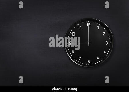 analog wall clock showing nine o'clock Stock Photo - Alamy