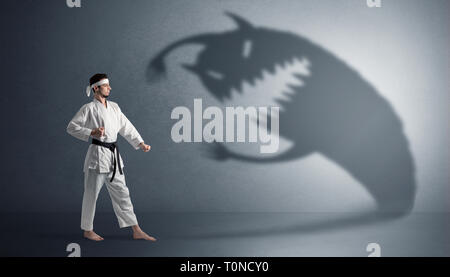 Young karate man fighting with a big black scary shadow Stock Photo - Alamy