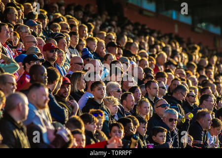 Faces in a football crowd standing all looking in the same direction ...