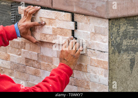 Worker Installing Wall Tile Cement with Trowel and Tile at Construction ...