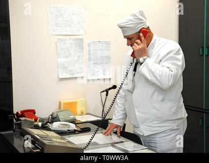 Chernobyl reactor 3 control room. Worker sat at the control panel of ...