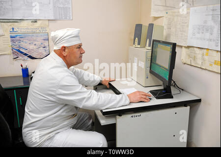 Chernobyl reactor 3 control room. Worker sat at the control panel of ...