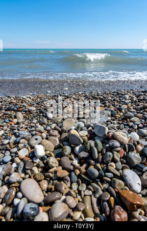 Stones on the shore of a lake on an early morning in september near ...