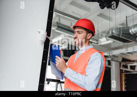 Confident Firefighter Holding Clipboard At Fire Station Stock Photo ...
