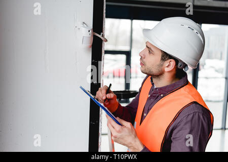 Confident Firefighter Holding Clipboard At Fire Station Stock Photo ...