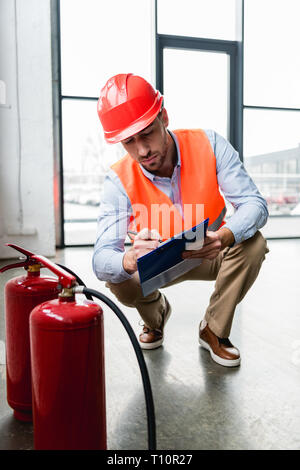 Fireman Writing On Clipboard Stock Photo - Alamy