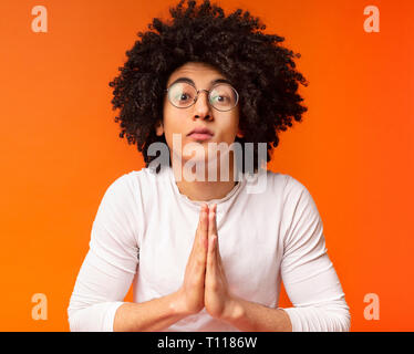 Man showing hands with clasped fingers against yellow background Stock ...