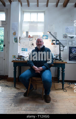 portrait of an artist sitting in their creative art studio shot for a ...