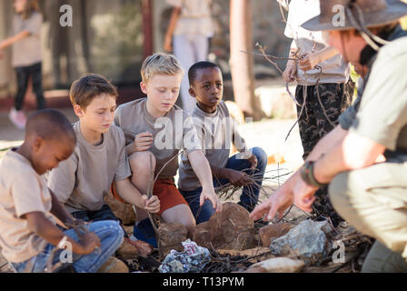 Children learning how to make a fire Stock Photo - Alamy