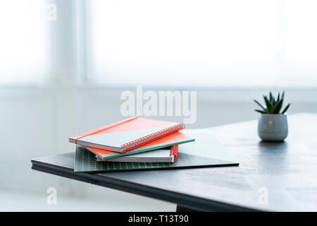 Stack of notebooks on a table Stock Photo - Alamy