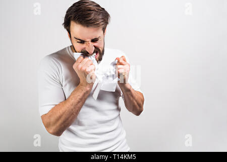 Angry man tearing paper in half home or in modern office at night ...