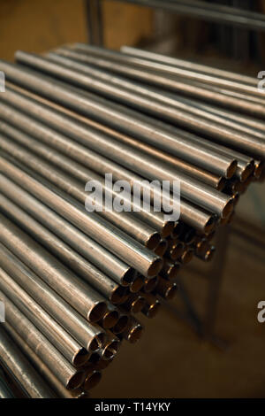metal pipes stored for work in work shop Stock Photo - Alamy